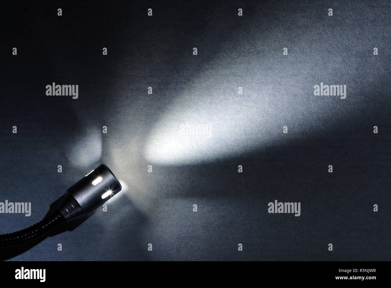 Dark background with beam from modern pocket flashlight Stock Photo - Alamy
