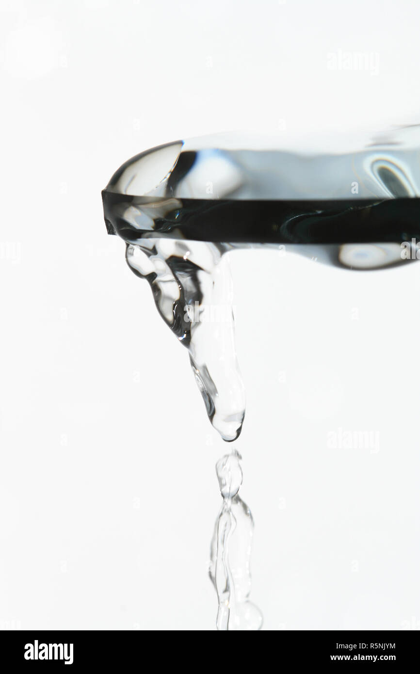 Piece of glass with flowing water on white background Stock Photo - Alamy