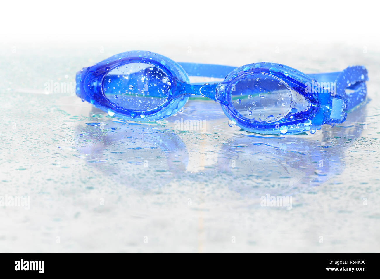 Blue wet swimming goggles on glass background with water drops Stock ...