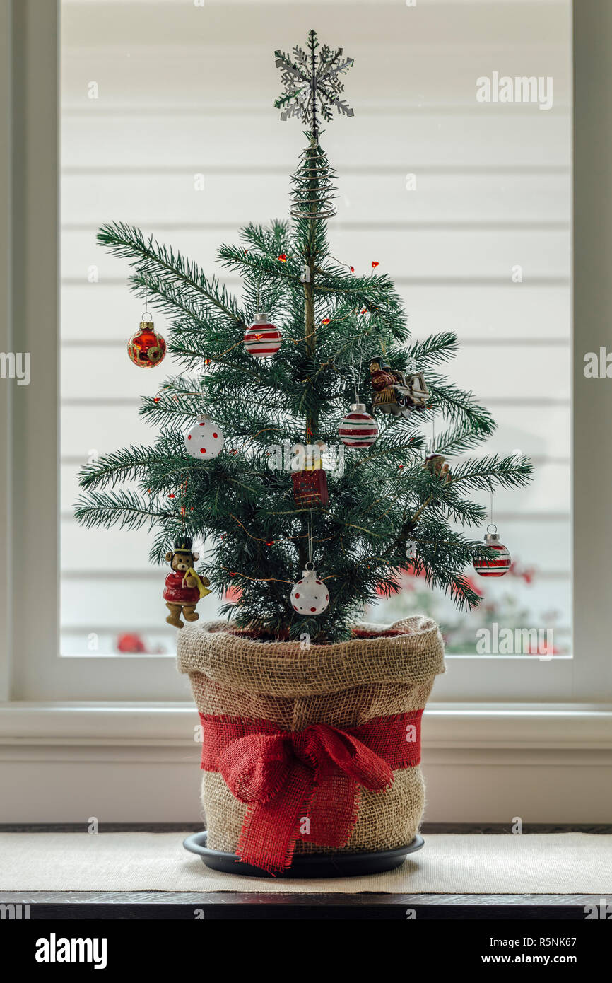 Small Christmas tree with decorations Stock Photo - Alamy