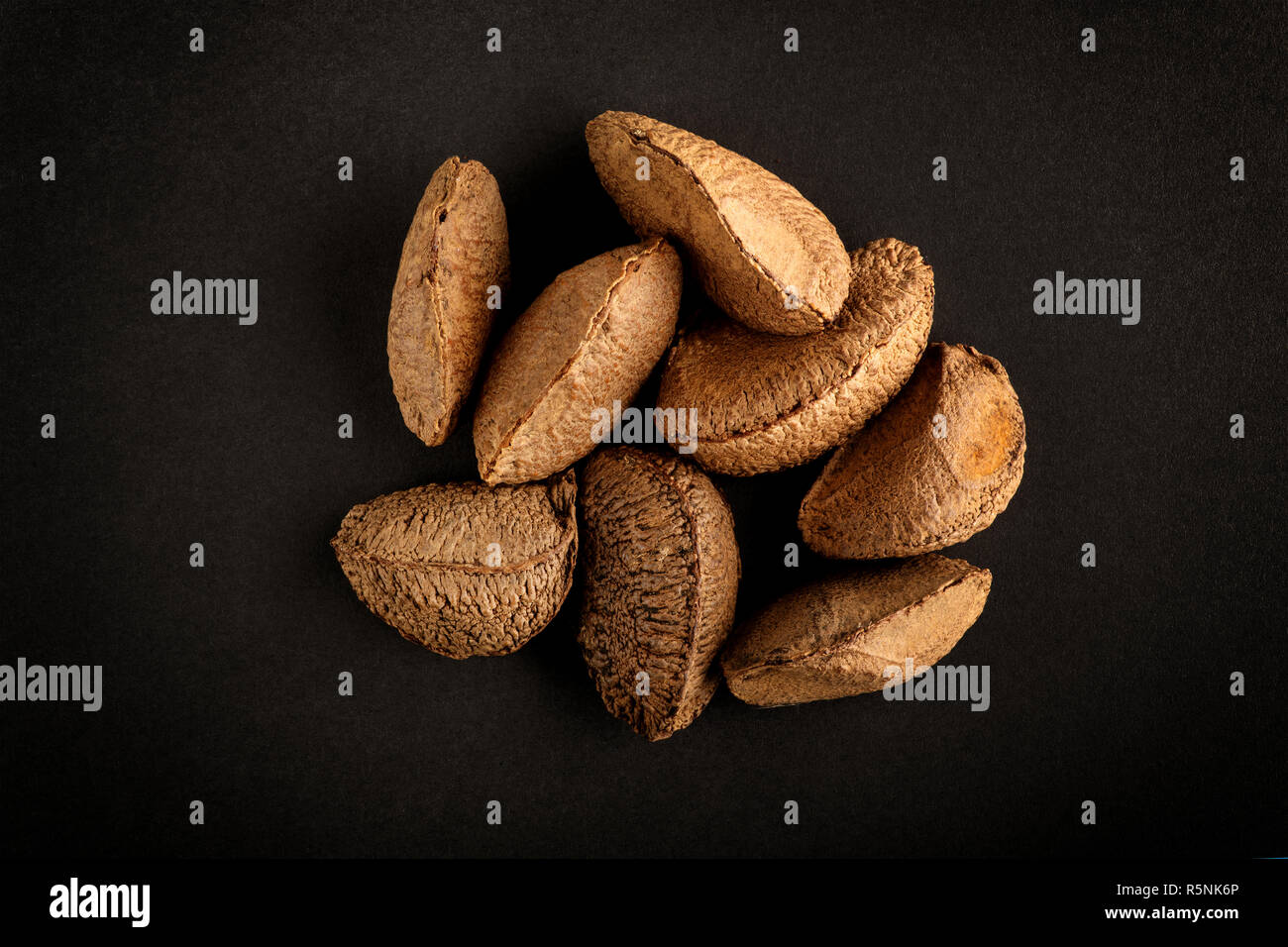 Small pile of raw brown brazil nuts in their natural shells, viewed ...