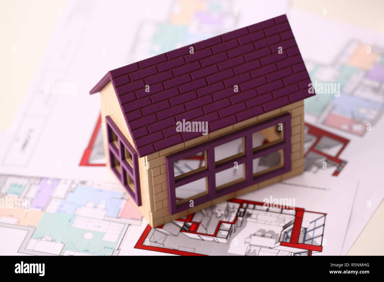 Small miniature house stands on drawing Stock Photo - Alamy