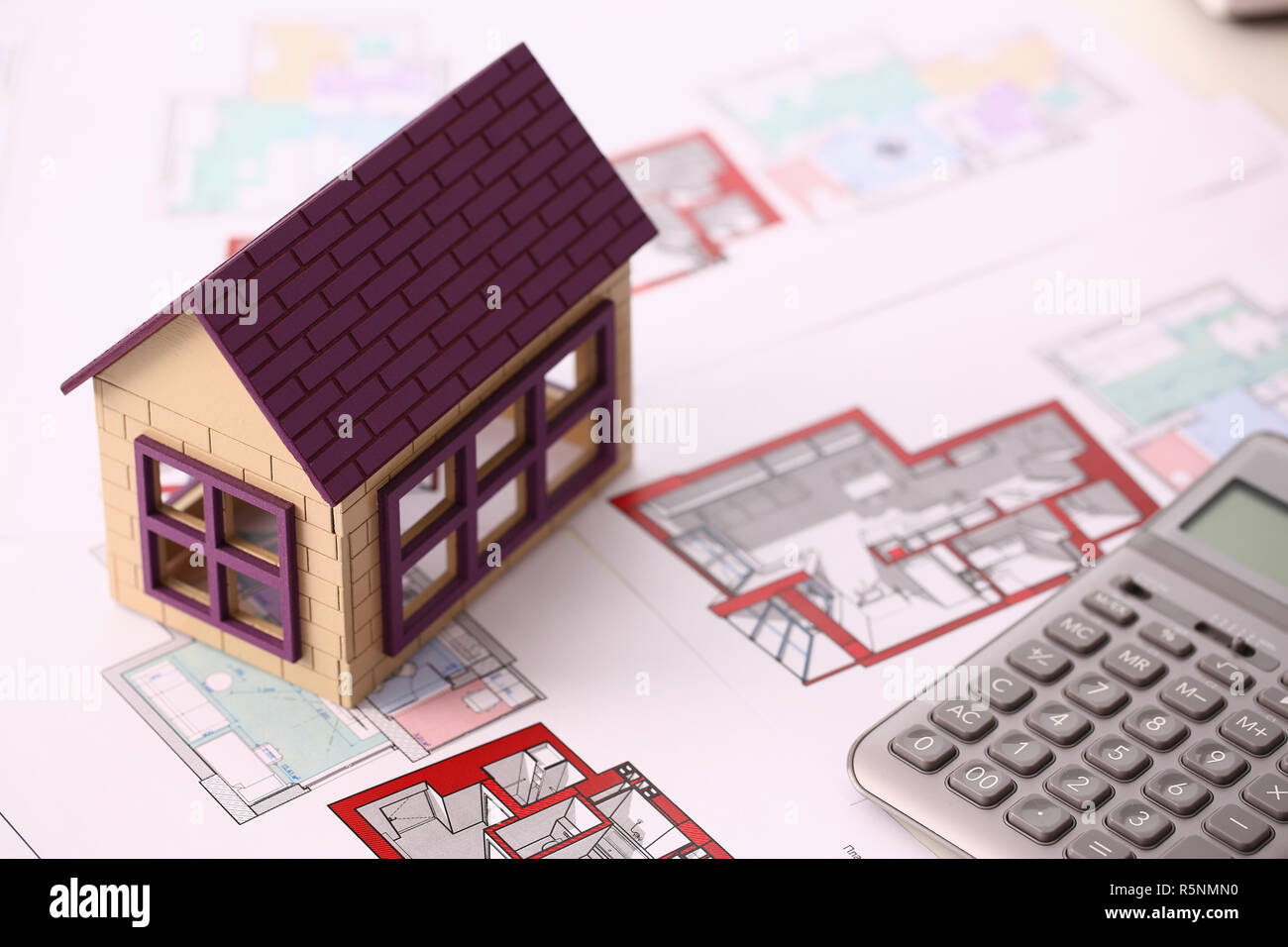 Small miniature house stands on drawing Stock Photo - Alamy
