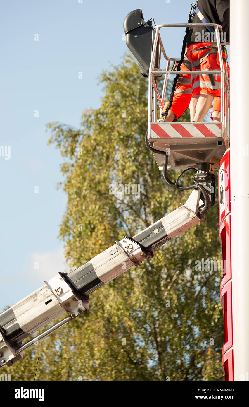Workers in aerial work platform Stock Photo - Alamy