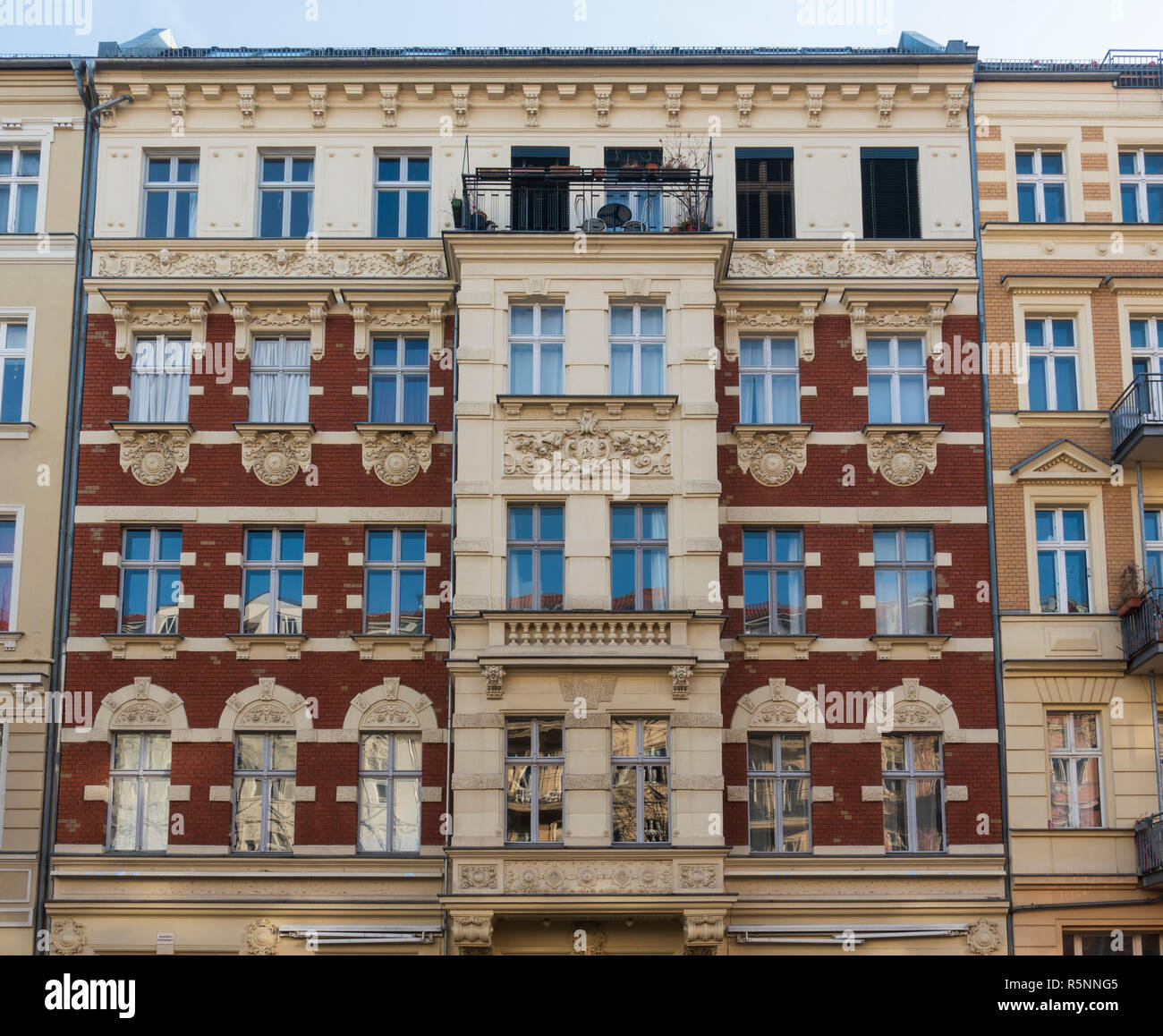 Detail of facade of ornate renovated old tenement apartment building in ...