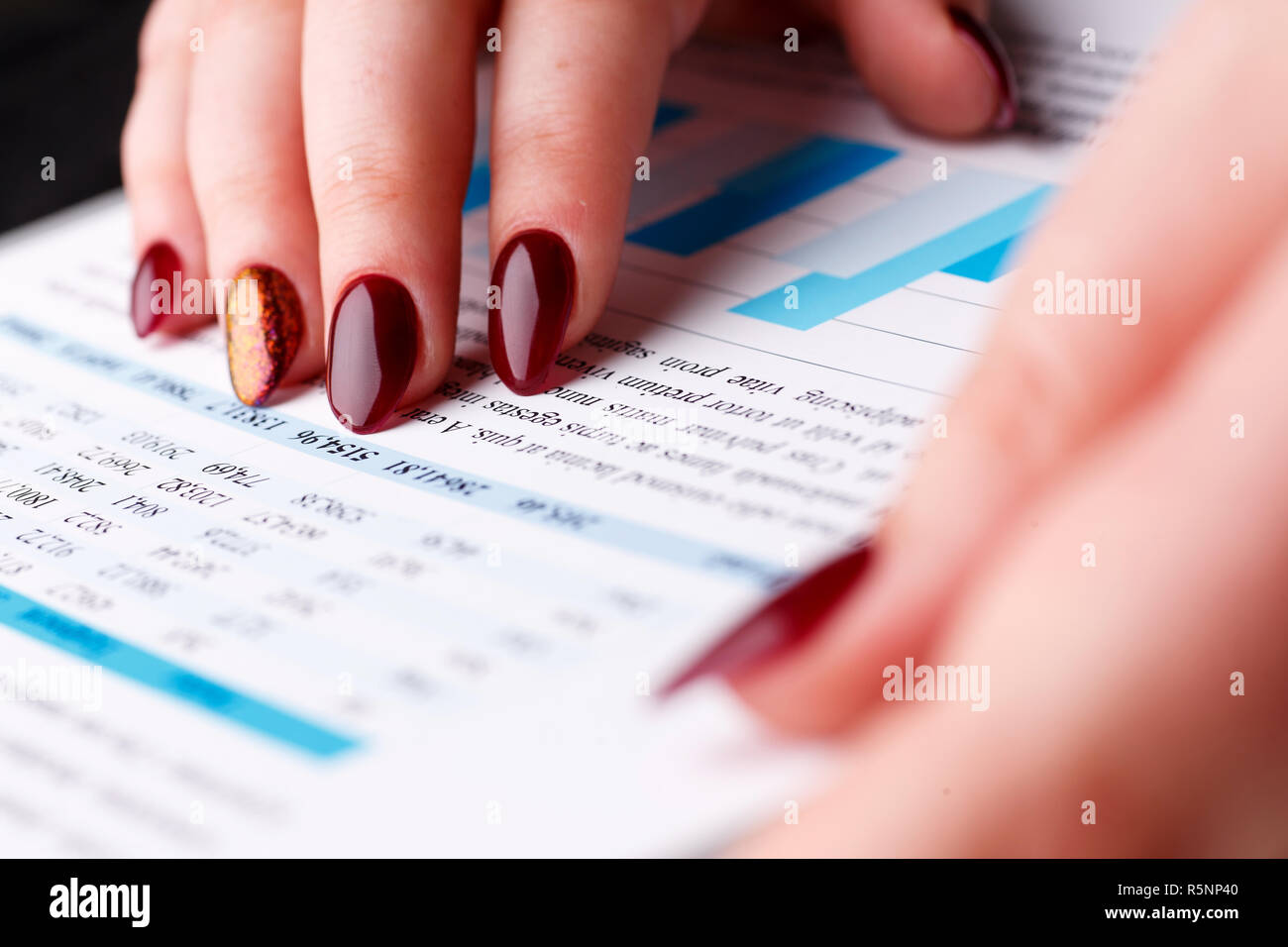 Female arm point finger in financial graph Stock Photo - Alamy