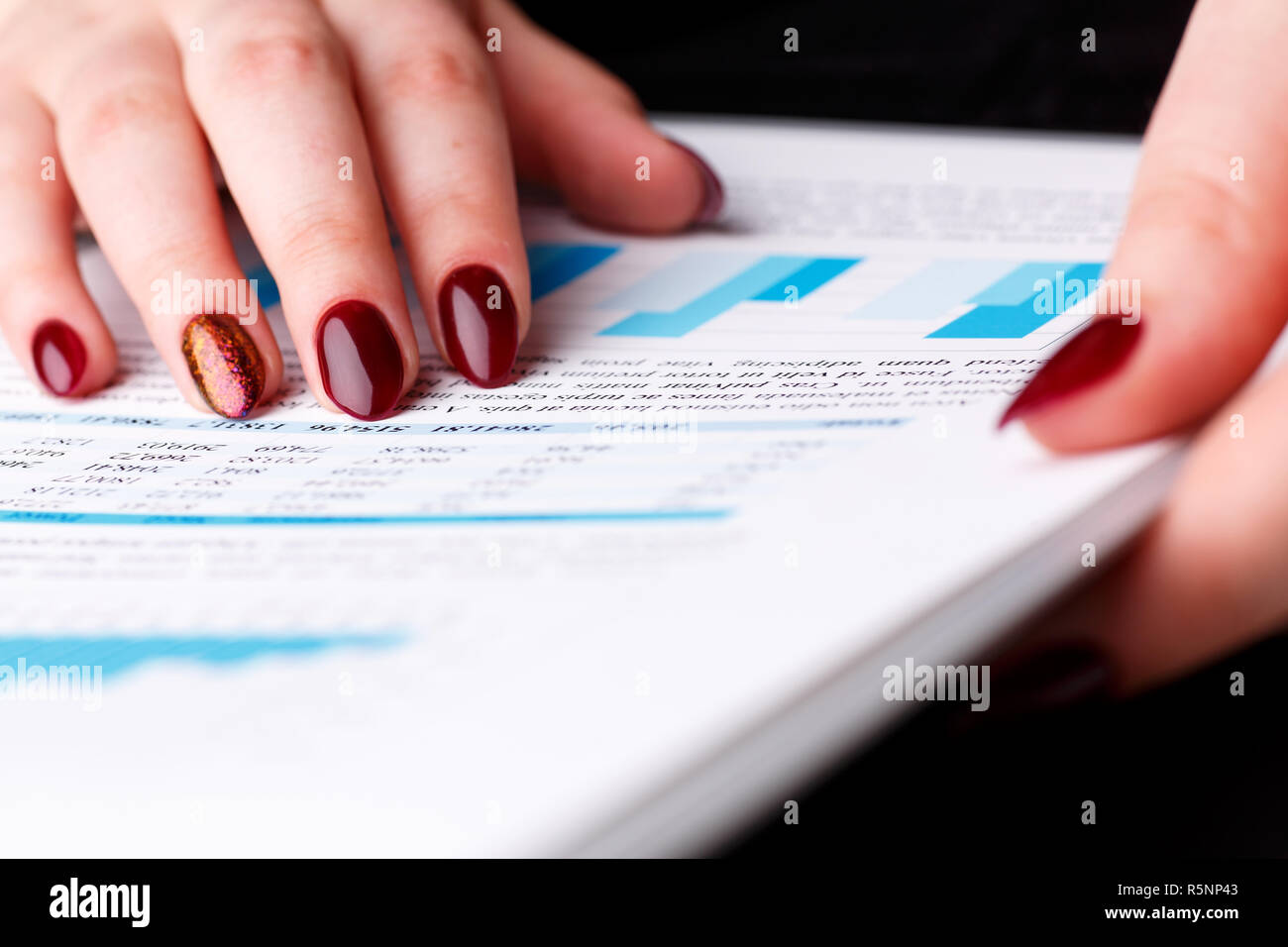 Female arm point finger in financial graph Stock Photo - Alamy