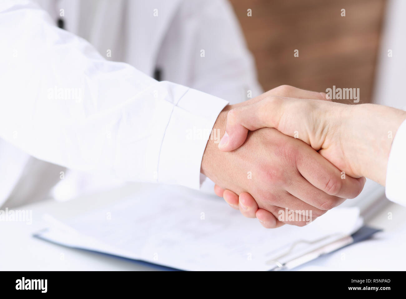 Doctor shake hand as hello with patient Stock Photo - Alamy