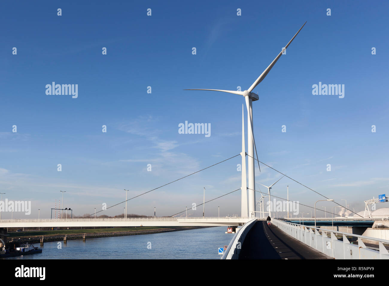 Wind turbines and an asphalted bicycle path Stock Photo - Alamy