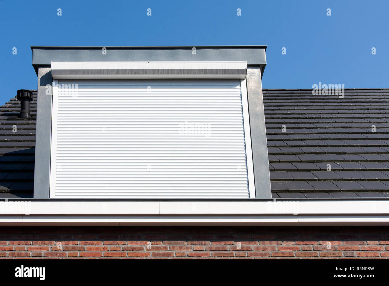 Dormer window with rolling safety shutter Stock Photo - Alamy