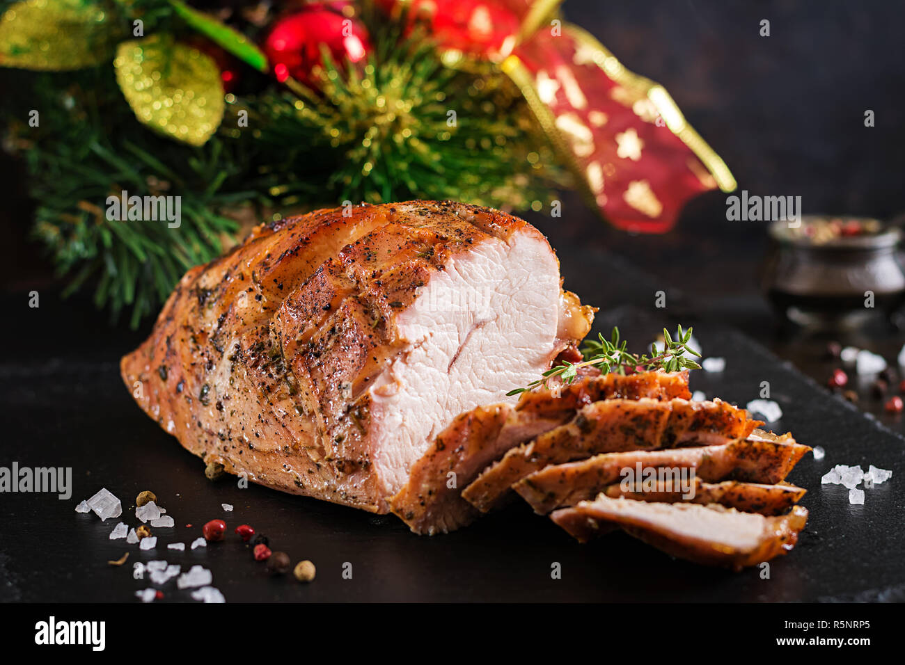 Roasted sliced Christmas ham of turkey on dark rustic background ...