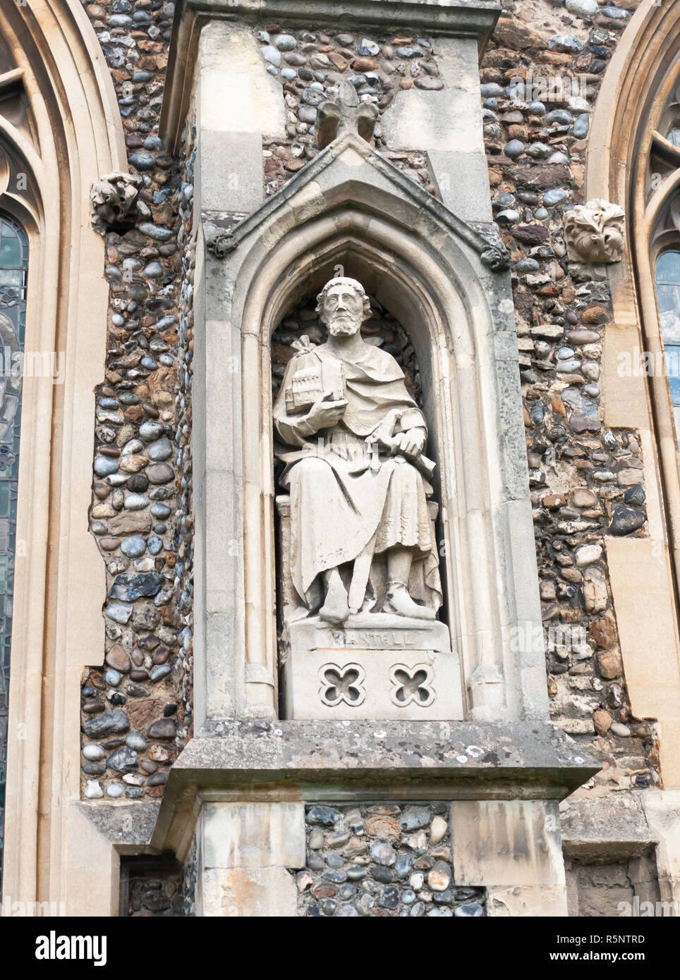 statue of man on the outside of english christian church made of stone ...