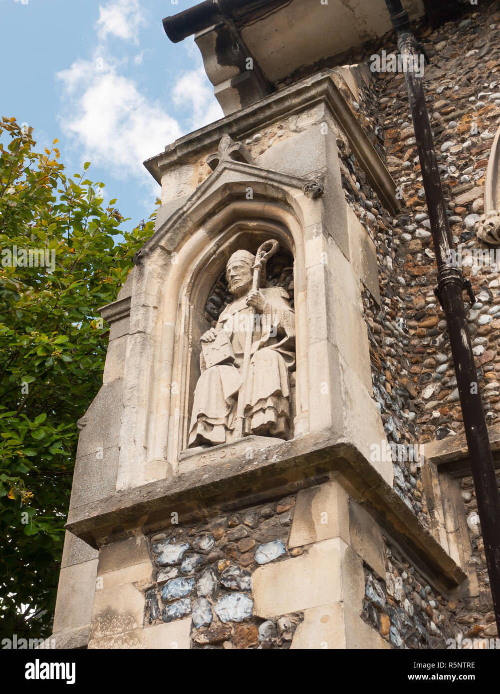 statue of priest on the outside of english christian church made of ...