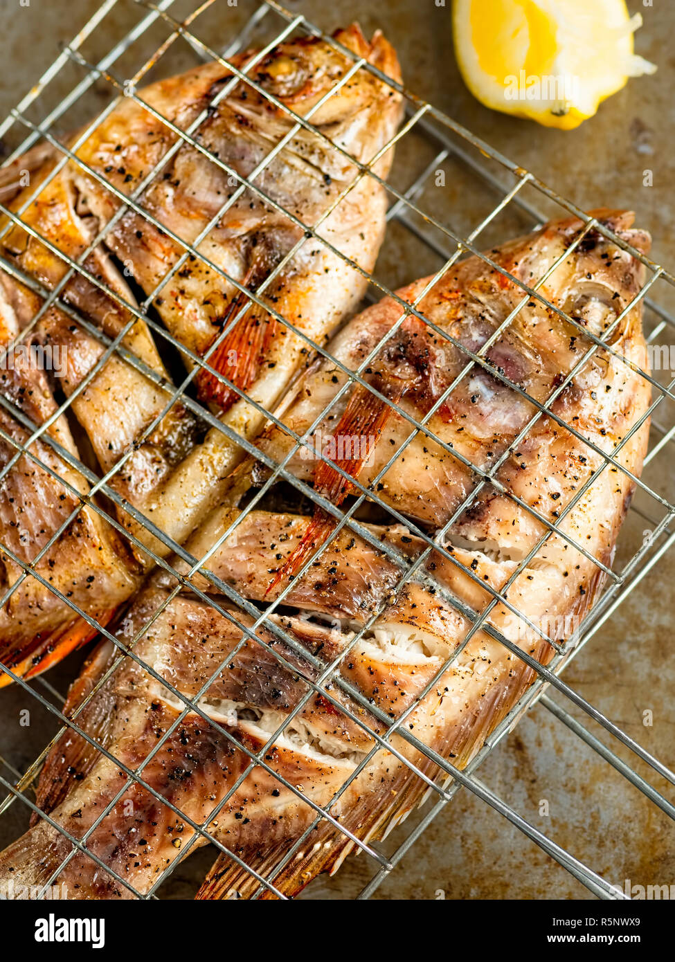 rustic barbecued grilled fish Stock Photo - Alamy