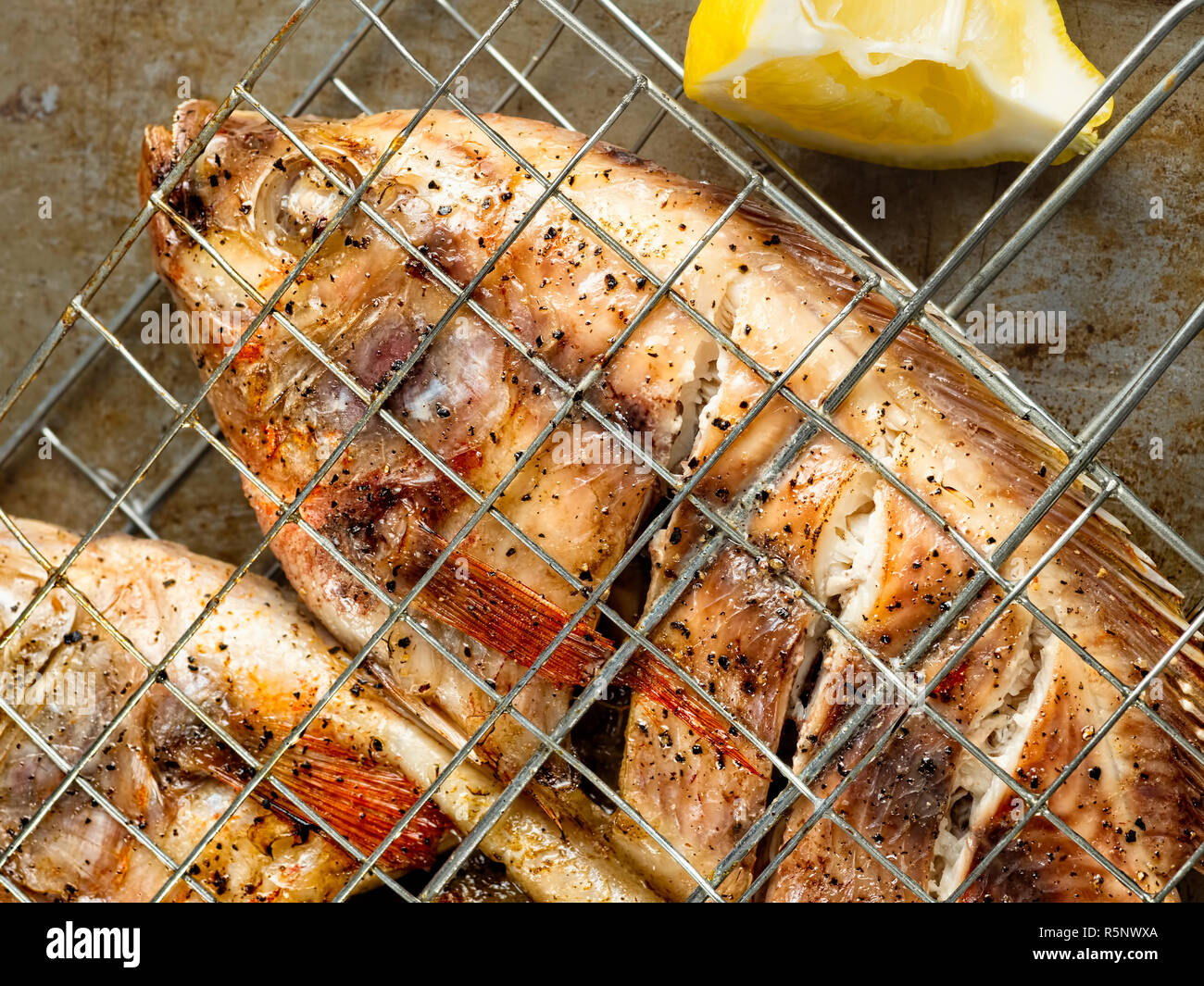 rustic barbecued grilled fish Stock Photo - Alamy