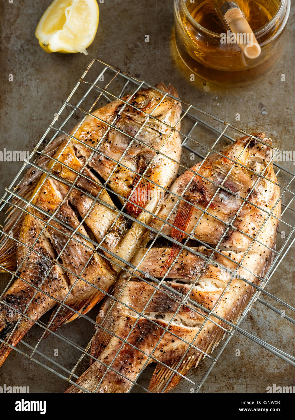 rustic barbecued grilled fish Stock Photo - Alamy