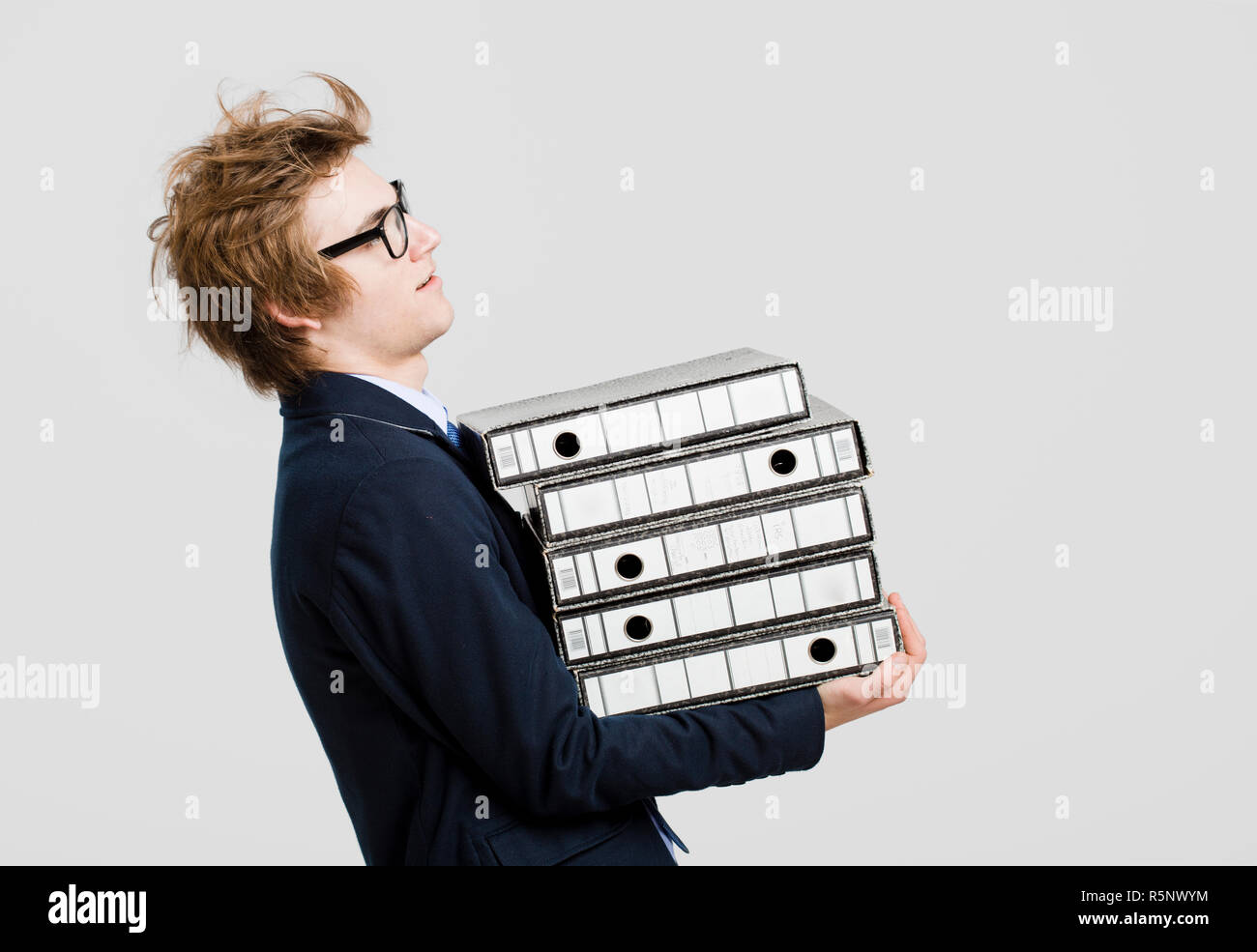 Business man carrying folders Stock Photo - Alamy