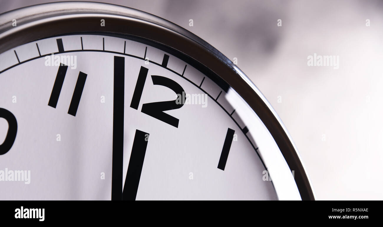 Wall clock showing five to twelve Stock Photo - Alamy