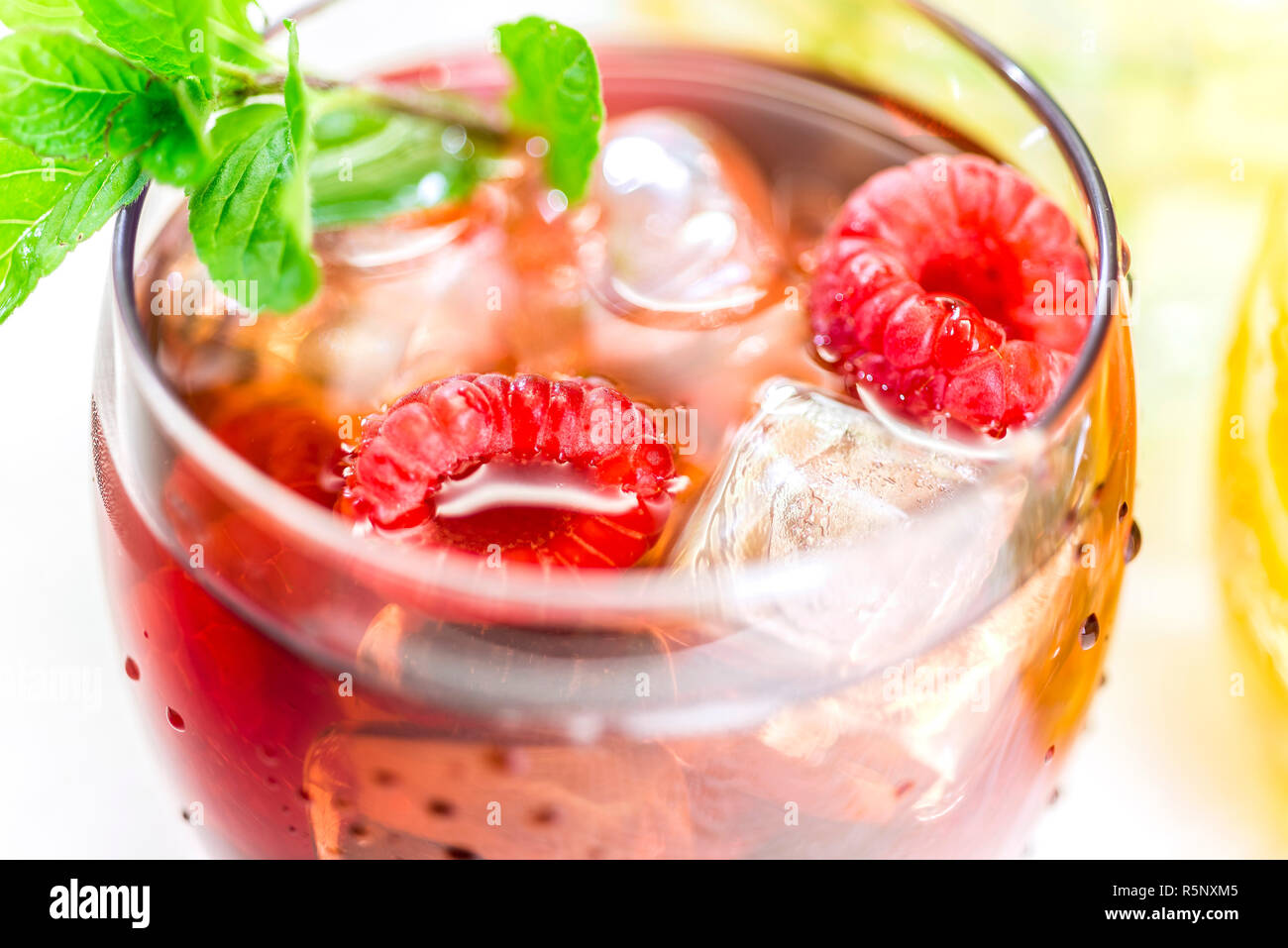 ice tea with fruits in bulbous low glasses Stock Photo - Alamy