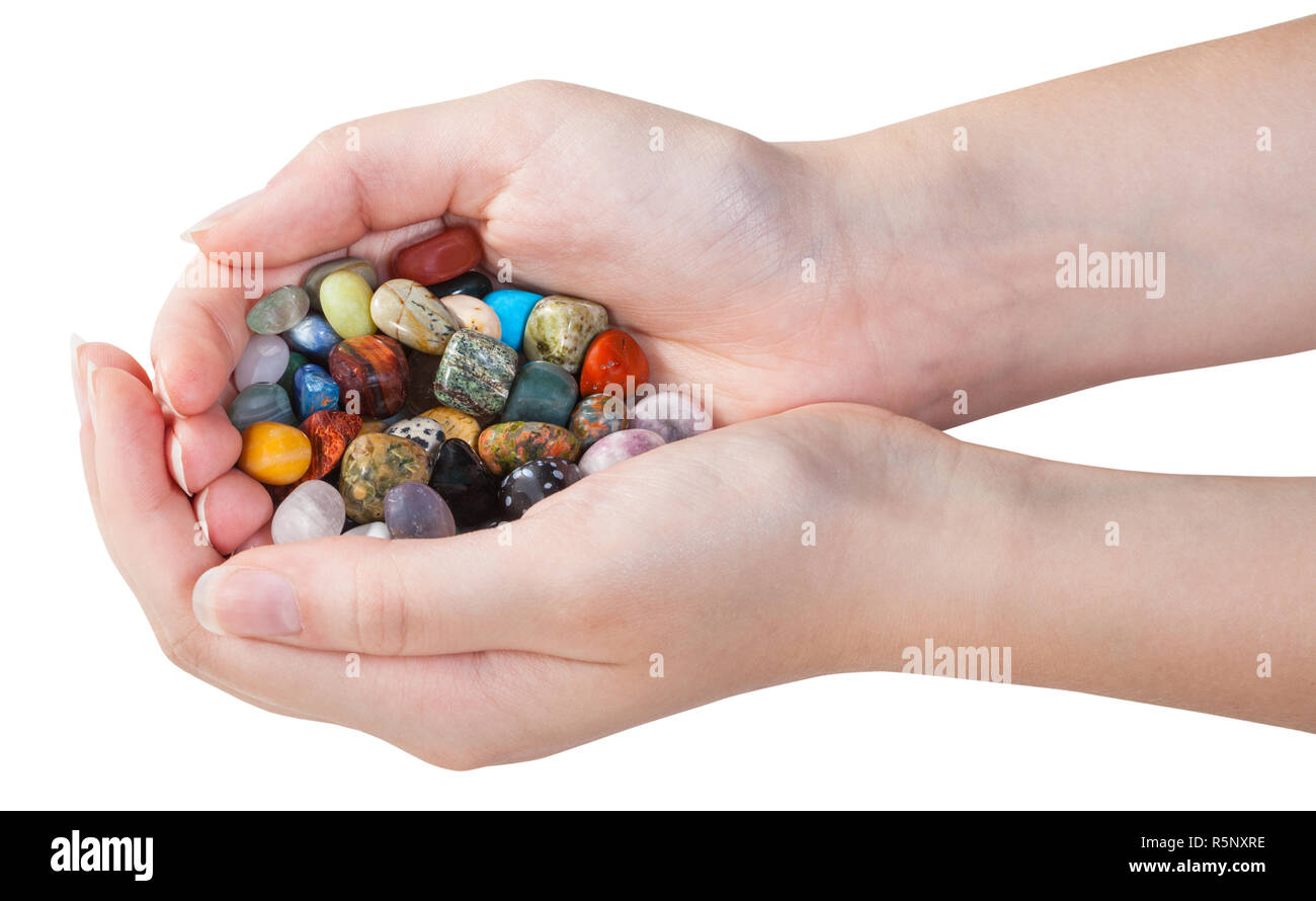 side view of handful with various gemstones Stock Photo - Alamy