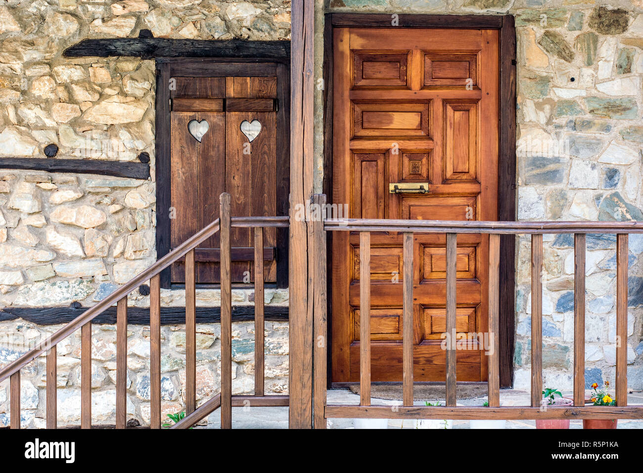 The front door window and stone wall of a traditional village house ...