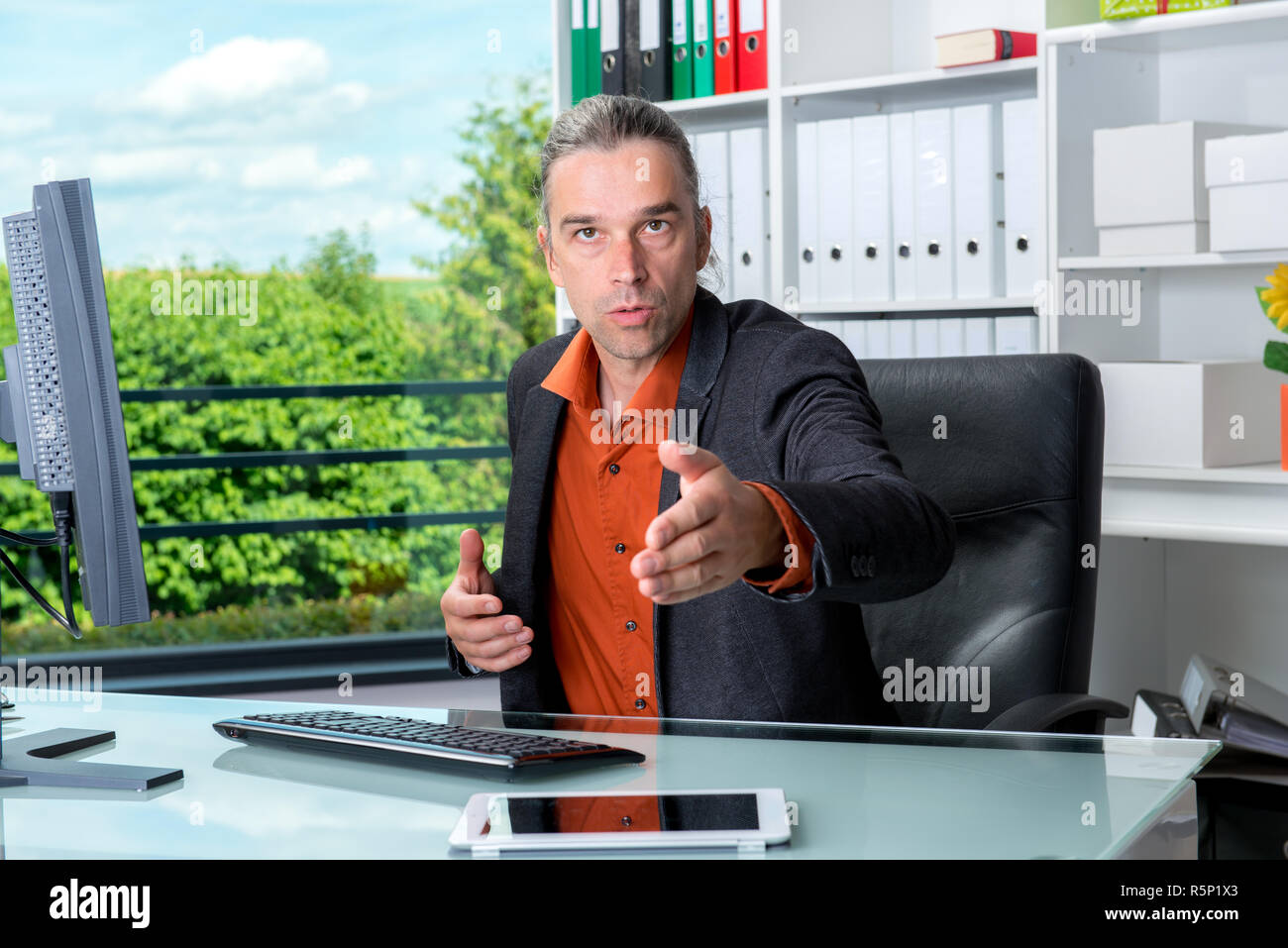 business man behind his desk greeted a client Stock Photo - Alamy