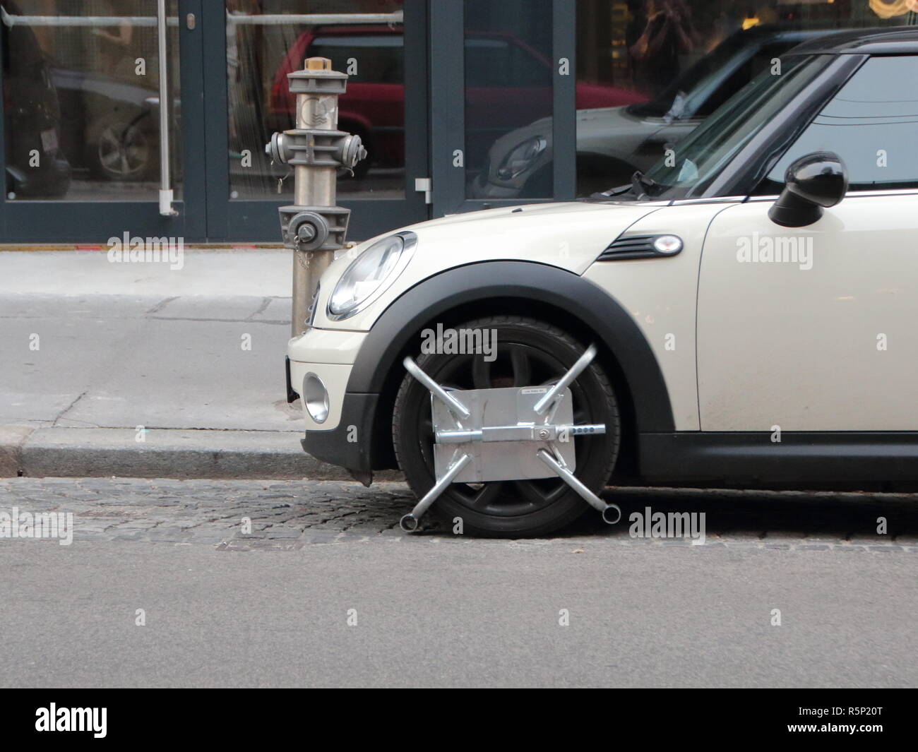 Small Car with Wheel Block Parked at Fire Hydrant Stock Photo - Alamy