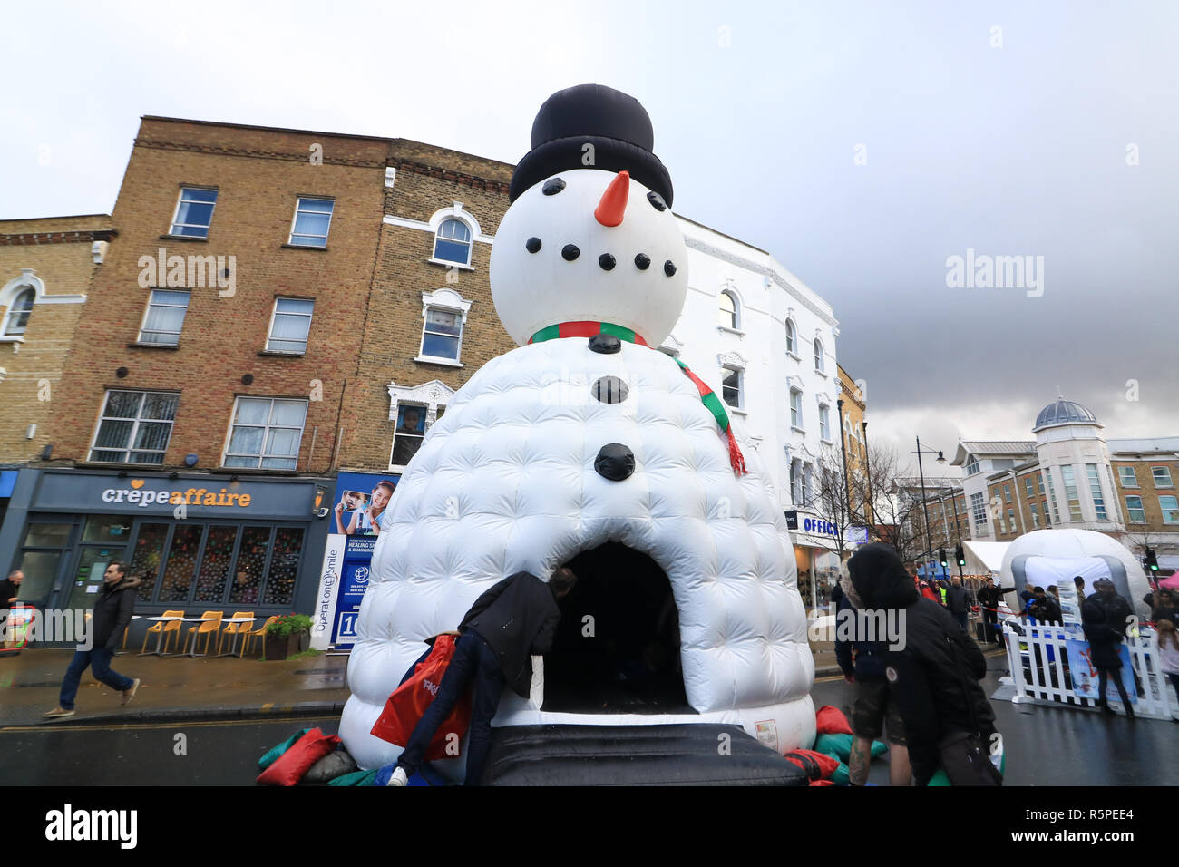London UK. 2nd December 2018.A giant inflatable snowman is erected in ...