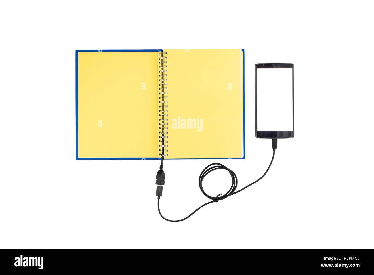 Above view of a cellphone connected to a textbook through usb. Isolated ...