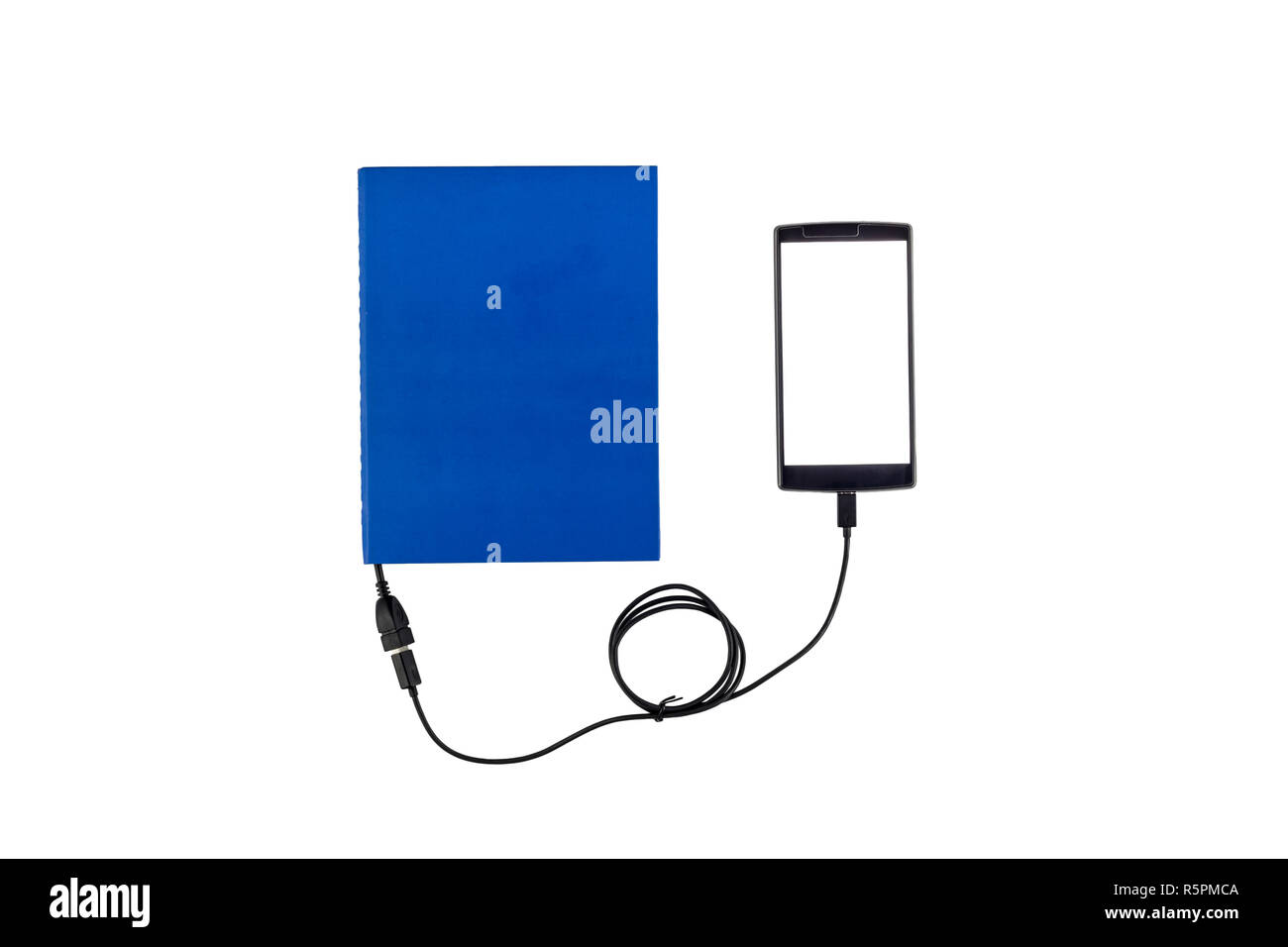 Above view of a cellphone connected to a textbook through usb. Isolated ...