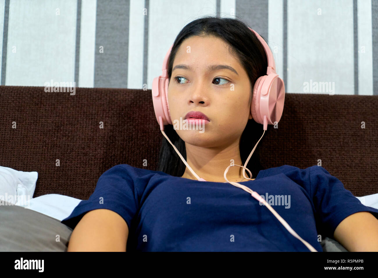 Beautiful women posing - thinking while listening music Stock Photo - Alamy