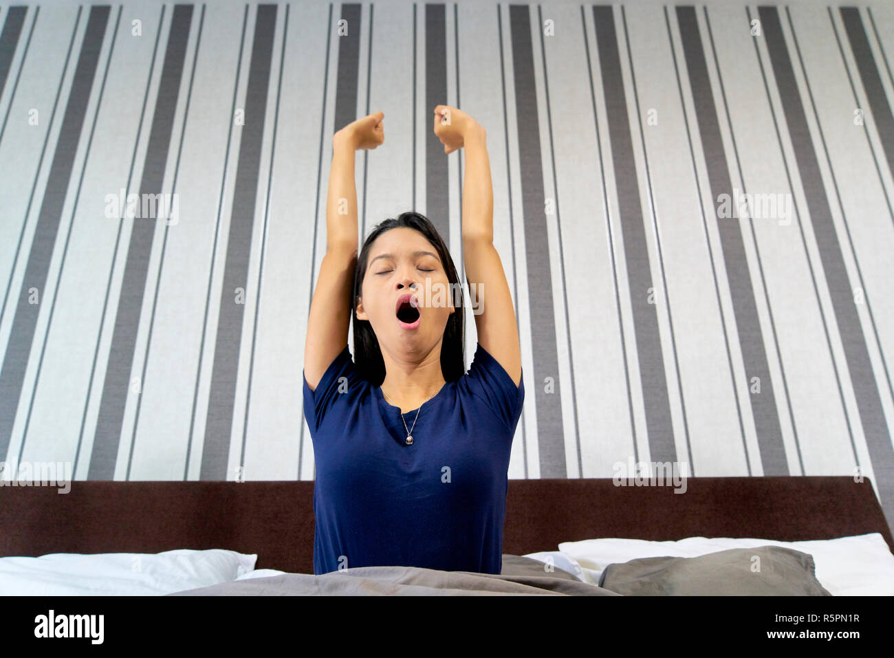 Beautiful women posing - raising her hands, yawning, tired Stock Photo ...