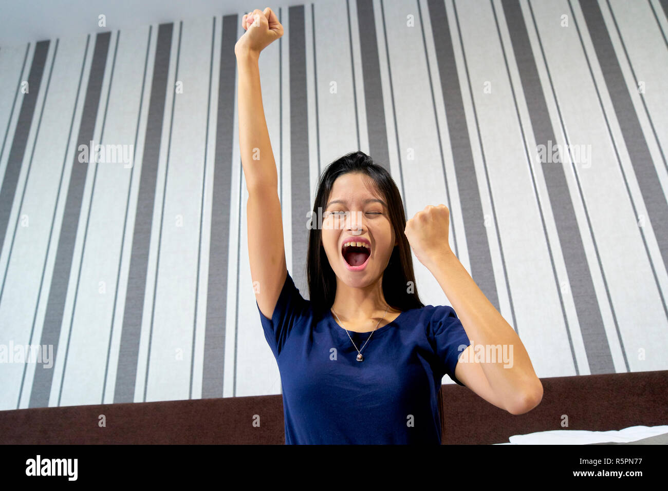 Beautiful women posing - raised her hand, winning, facial expression ...