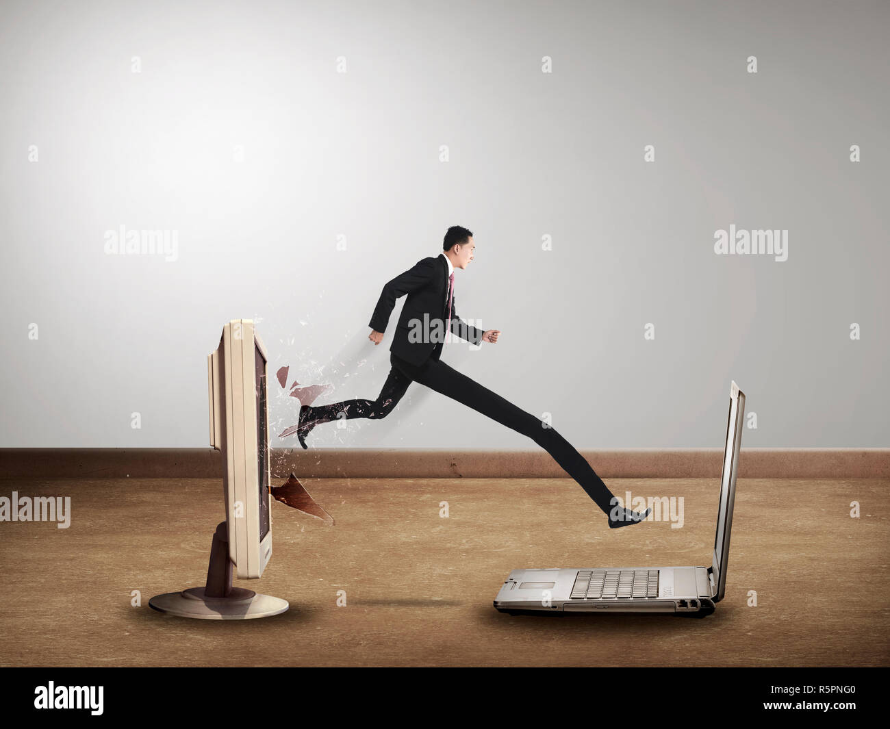 Business man with long leg out from computer desktop to laptop Stock ...