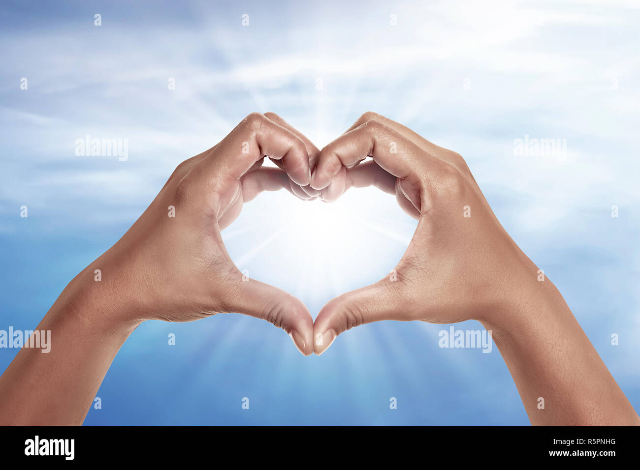 heart shaped hand with blue sky background Stock Photo - Alamy