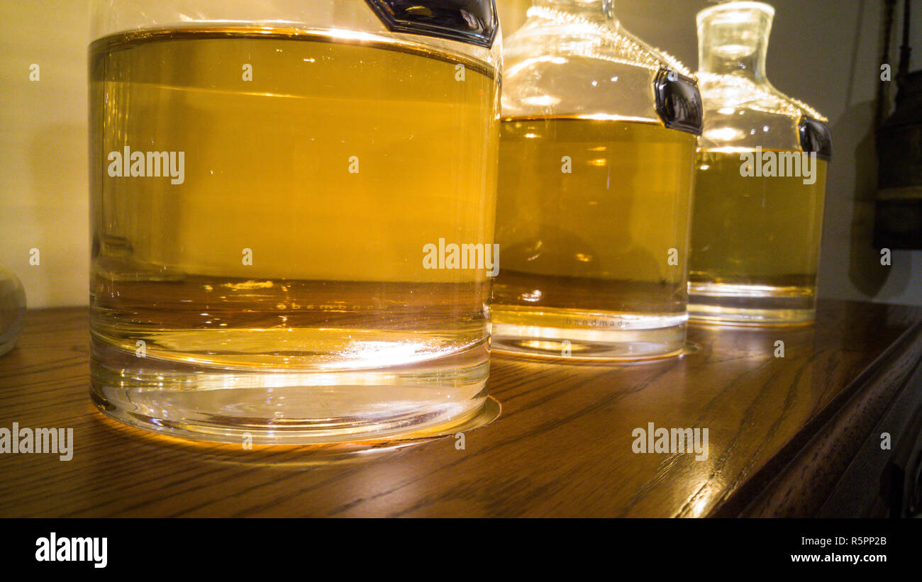 Jars of unblended whiskey from malted barley, maize and unmalted barley ...