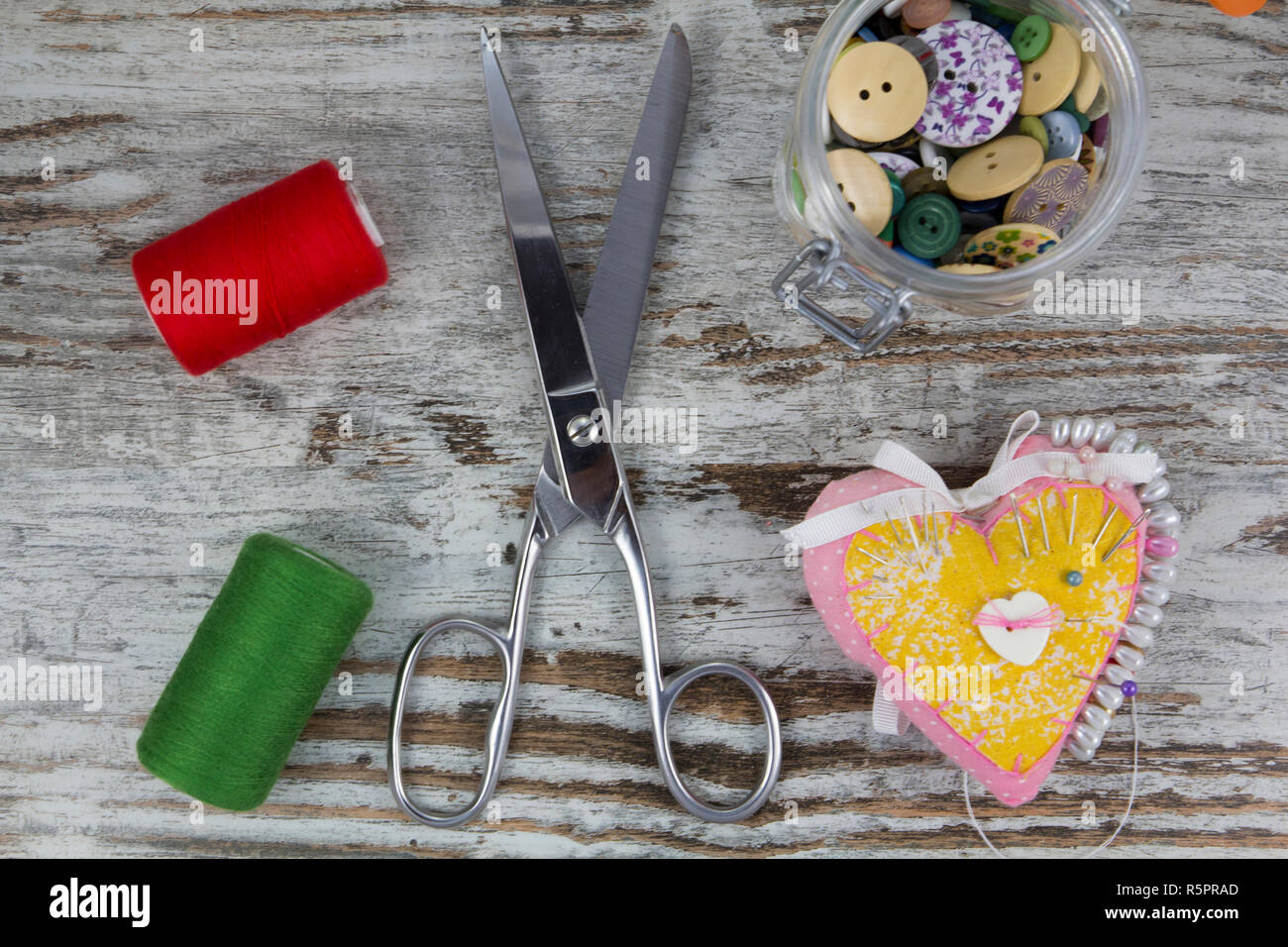 Sewing tools in a wooden background, vintage Stock Photo - Alamy