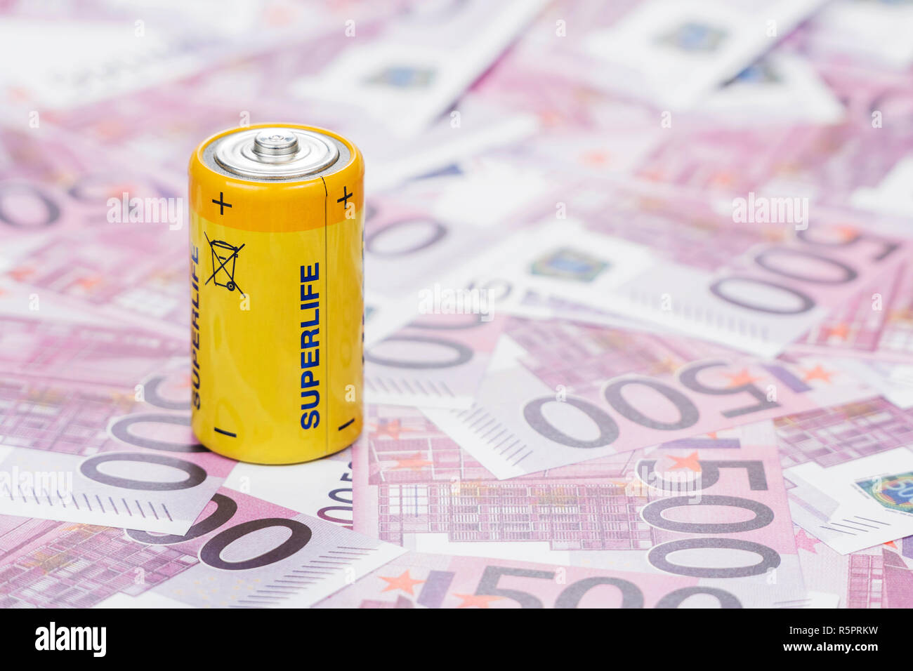 Big yellow battery on the money in denominations of five hundred euro ...
