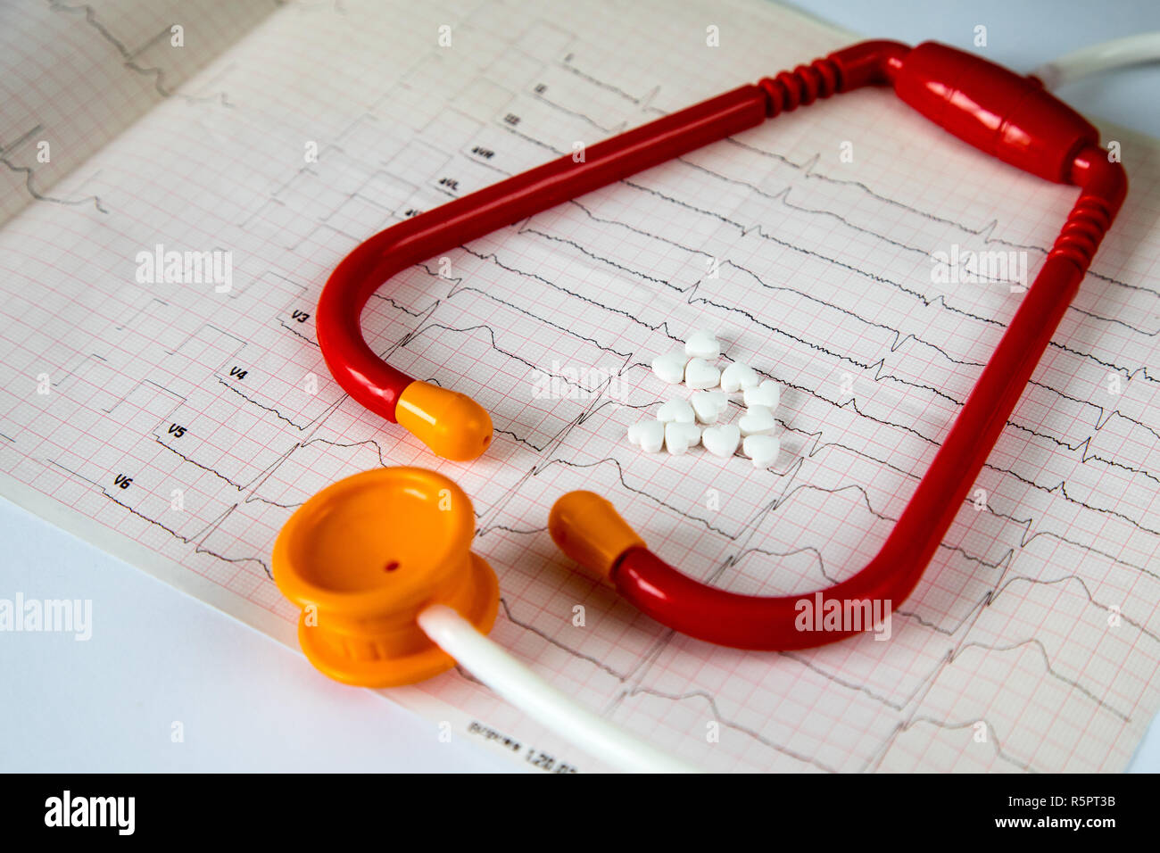 Cardiology. Macro of ECG graph and cardio pills. Pills as a heart Stock ...