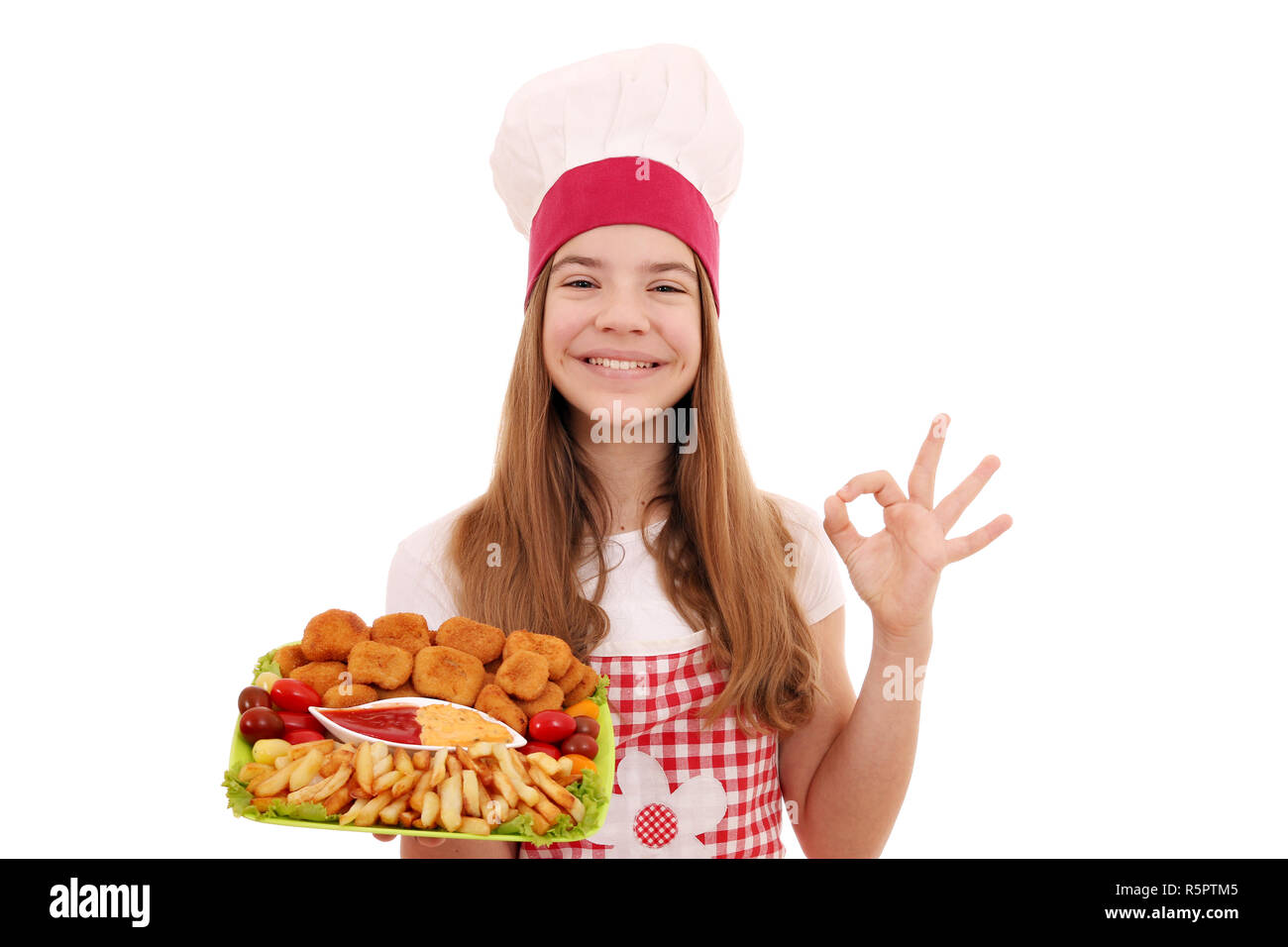 Happy girl cook with chicken nuggets and ok hand sign Stock Photo - Alamy