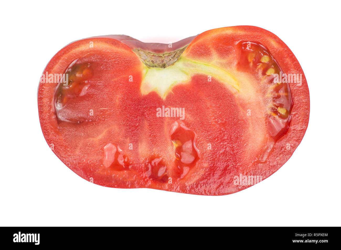 Closeup shot of a cross section of a pink tomato isolated on white ...