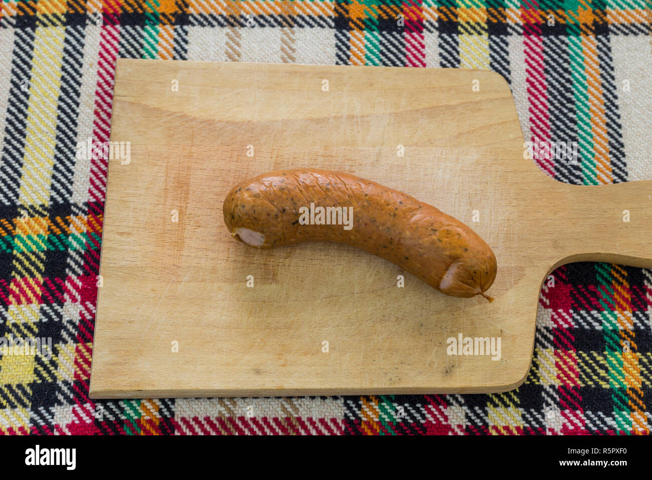 Cutting traditional Bulgarian sausage with herbs and spices called ...