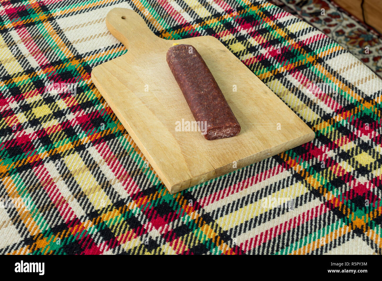 Cutting traditional Bulgarian flat sausage called lukanka Stock Photo ...