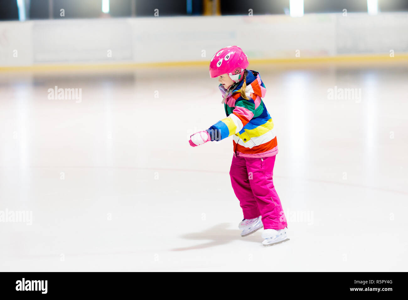 Child skating on indoor ice rink. Kids skate. Active family sport ...