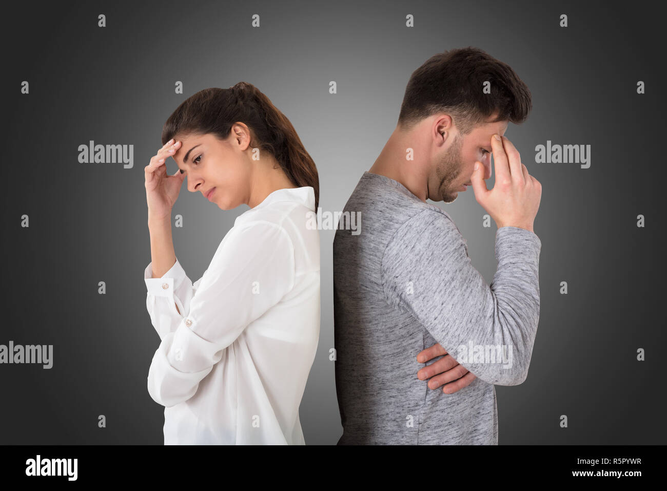 Frustrated Couple Standing Back To Back Stock Photo - Alamy