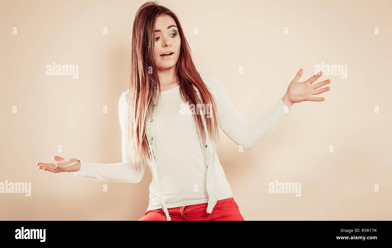 Negative emotions expression. Worried shocked girl in white shirt stand ...