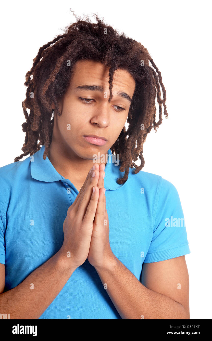 Young man praying against white background isolated Stock Photo - Alamy