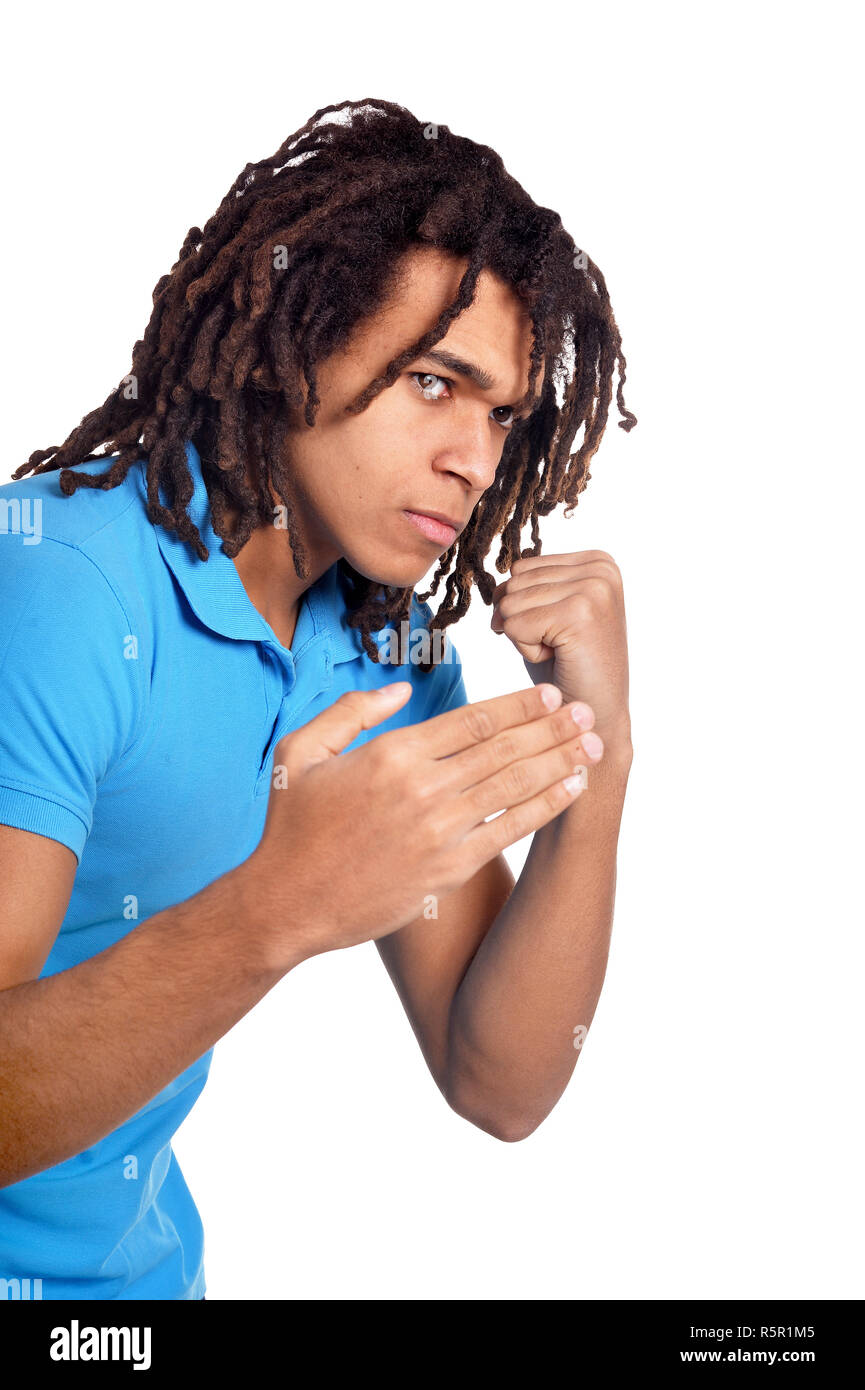 Young man fighting against white background isolated Stock Photo - Alamy