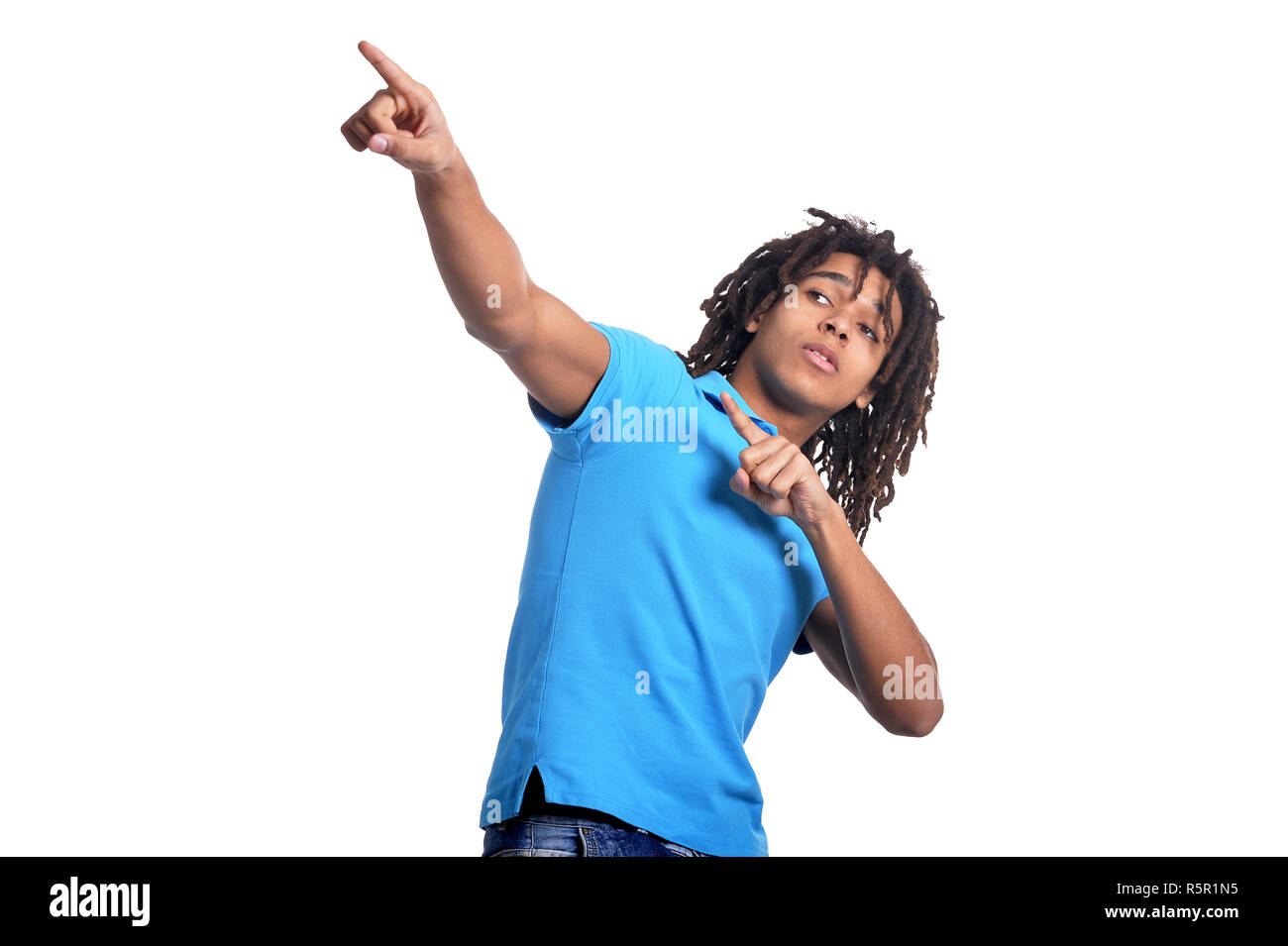 Young man pointing against white background isolated Stock Photo - Alamy