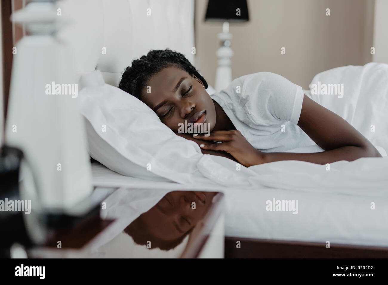African girl waking up in bed hi-res stock photography and images - Alamy